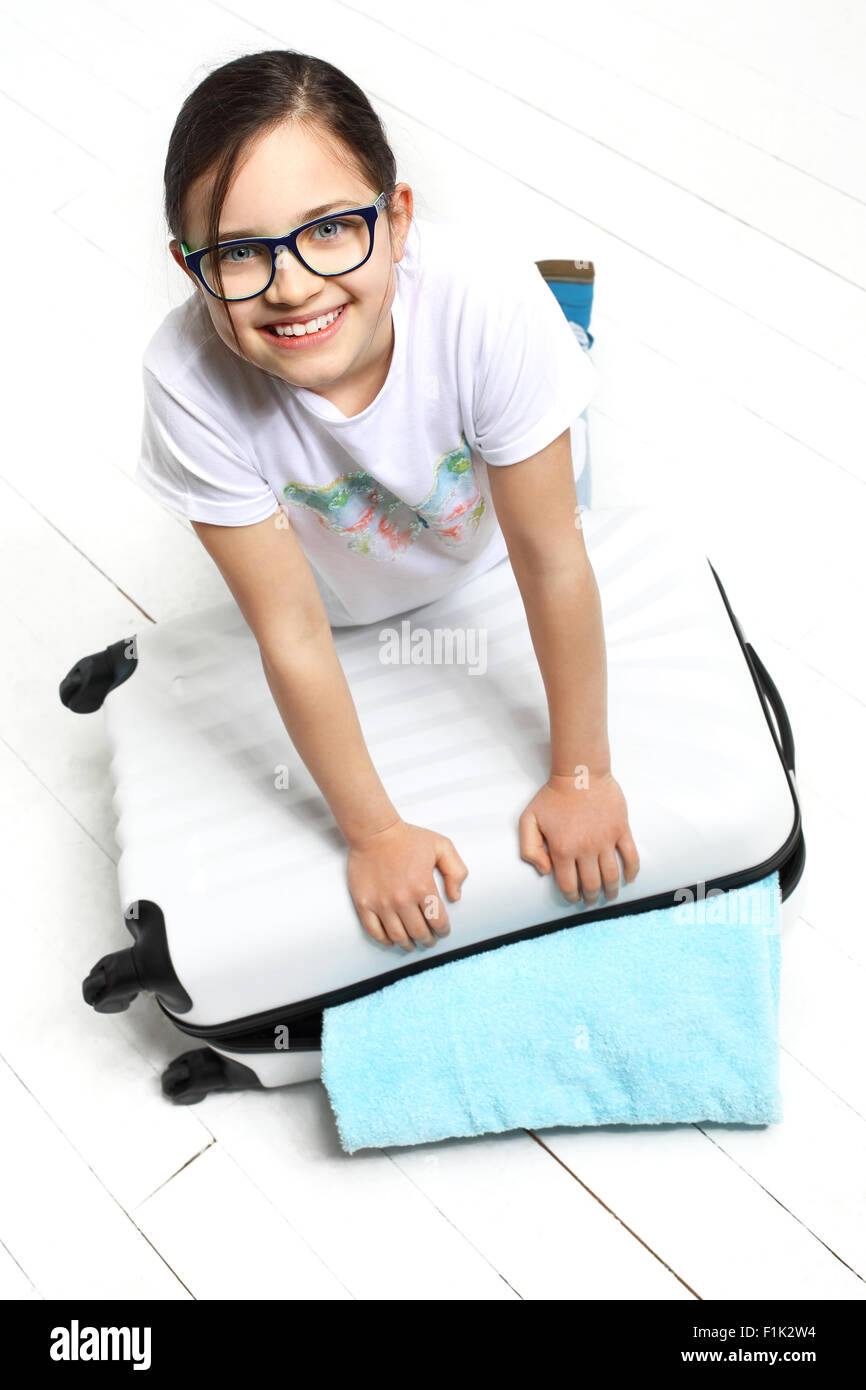 Girl packing suitcase hi-res stock photography and images - Alamy