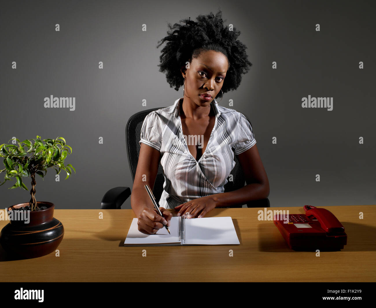 Woman writing at her desk Stock Photo - Alamy
