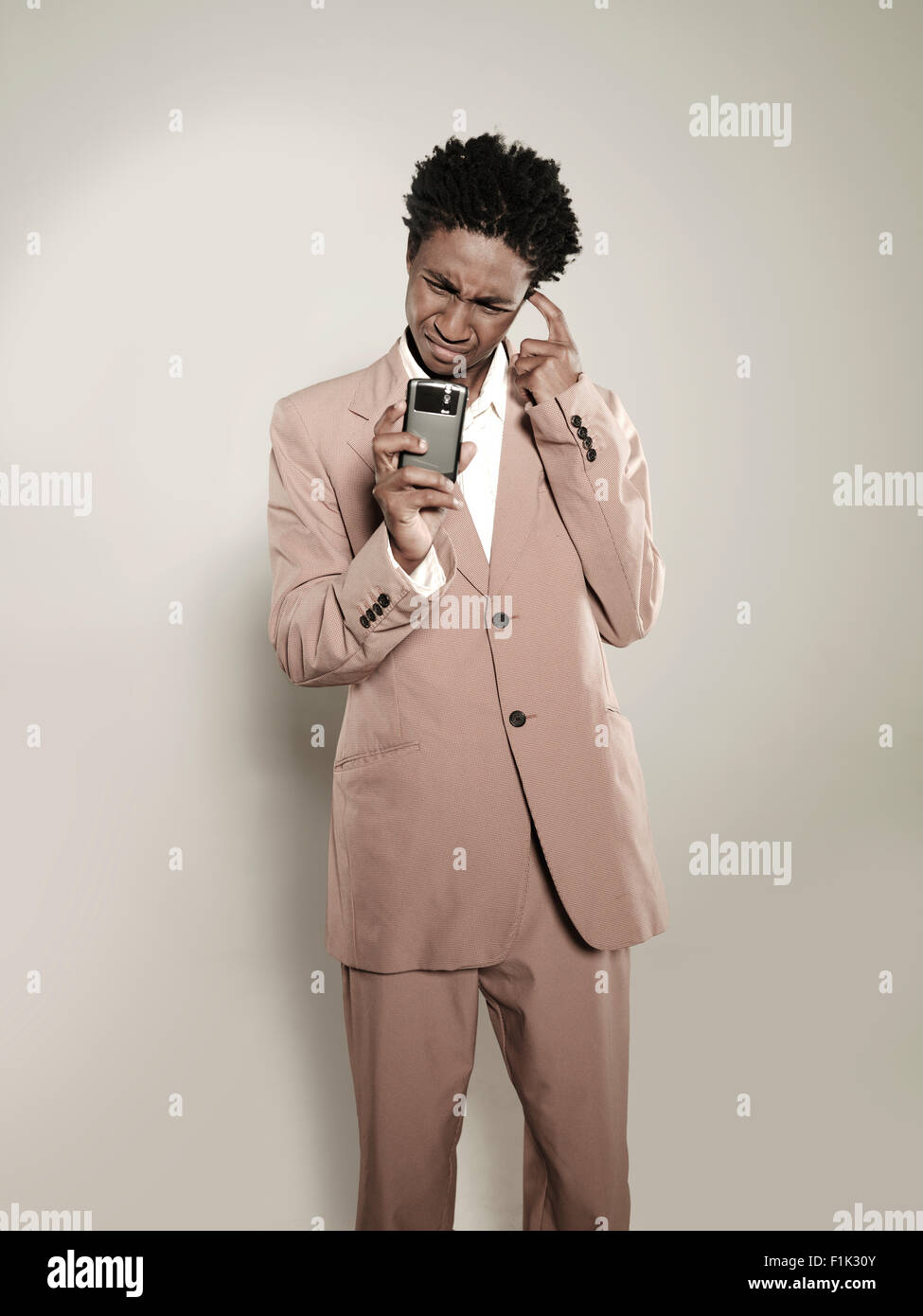 Portrait of Young funky Black man looking at cellphone Stock Photo - Alamy