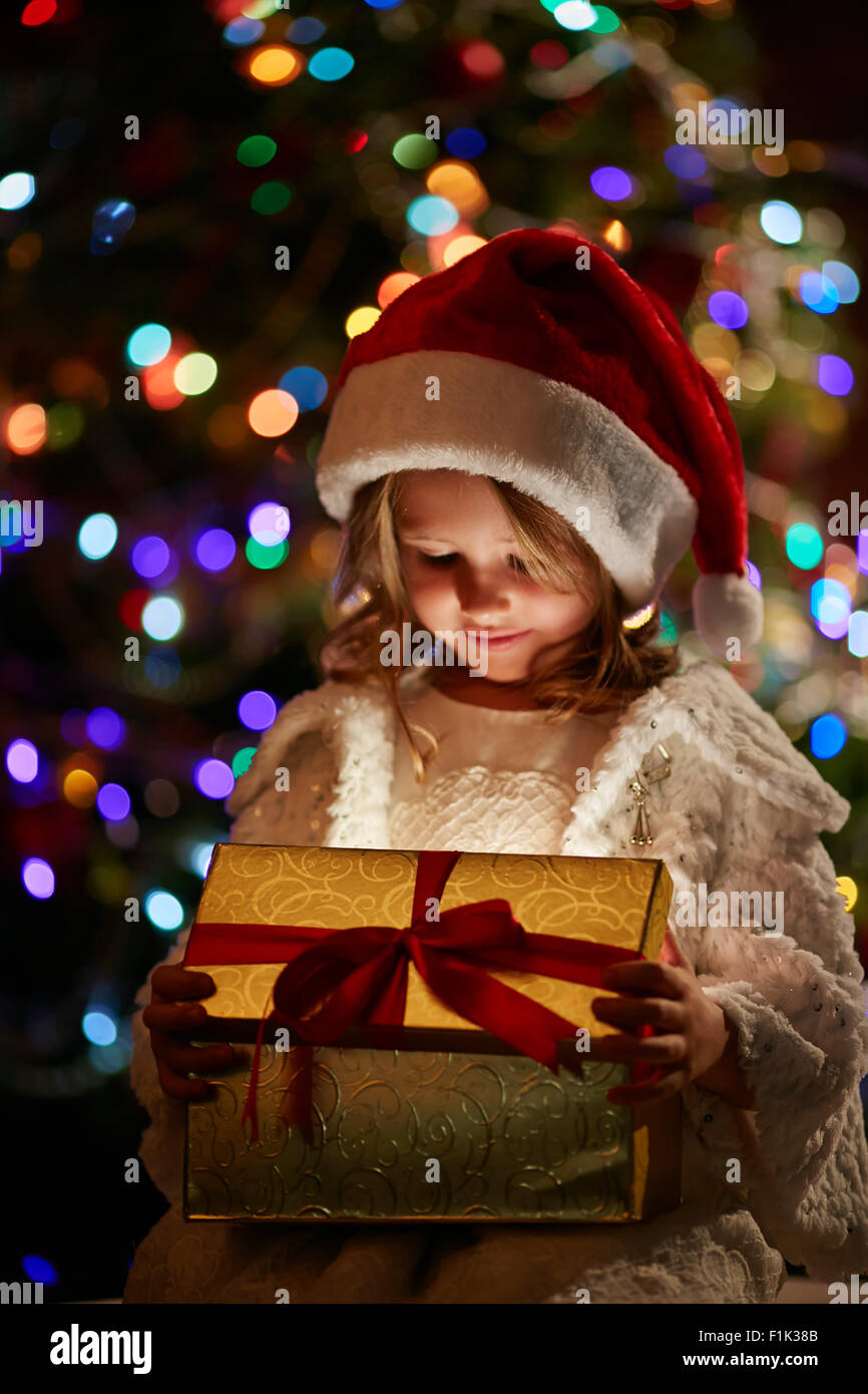 Little Santa with giftbox on sparkling background Stock Photo - Alamy