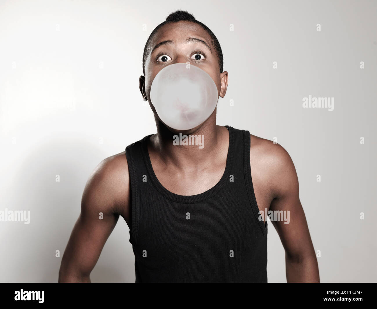 Portrait of funky Young man with chewing gum Stock Photo - Alamy