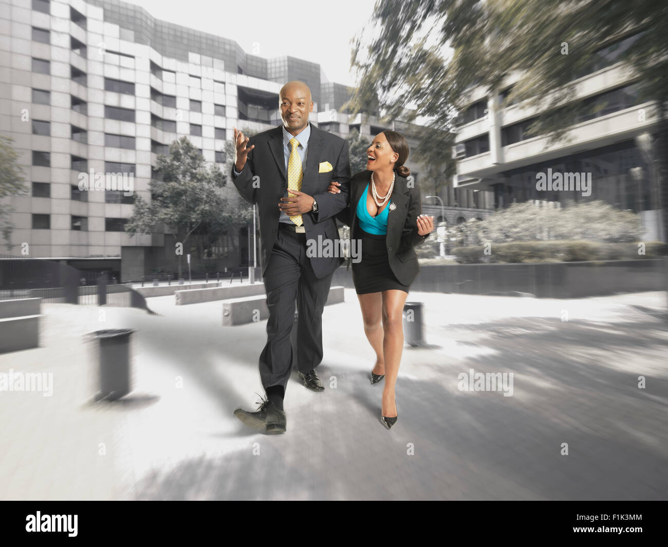 Business Couple walking fast and talking Stock Photo - Alamy
