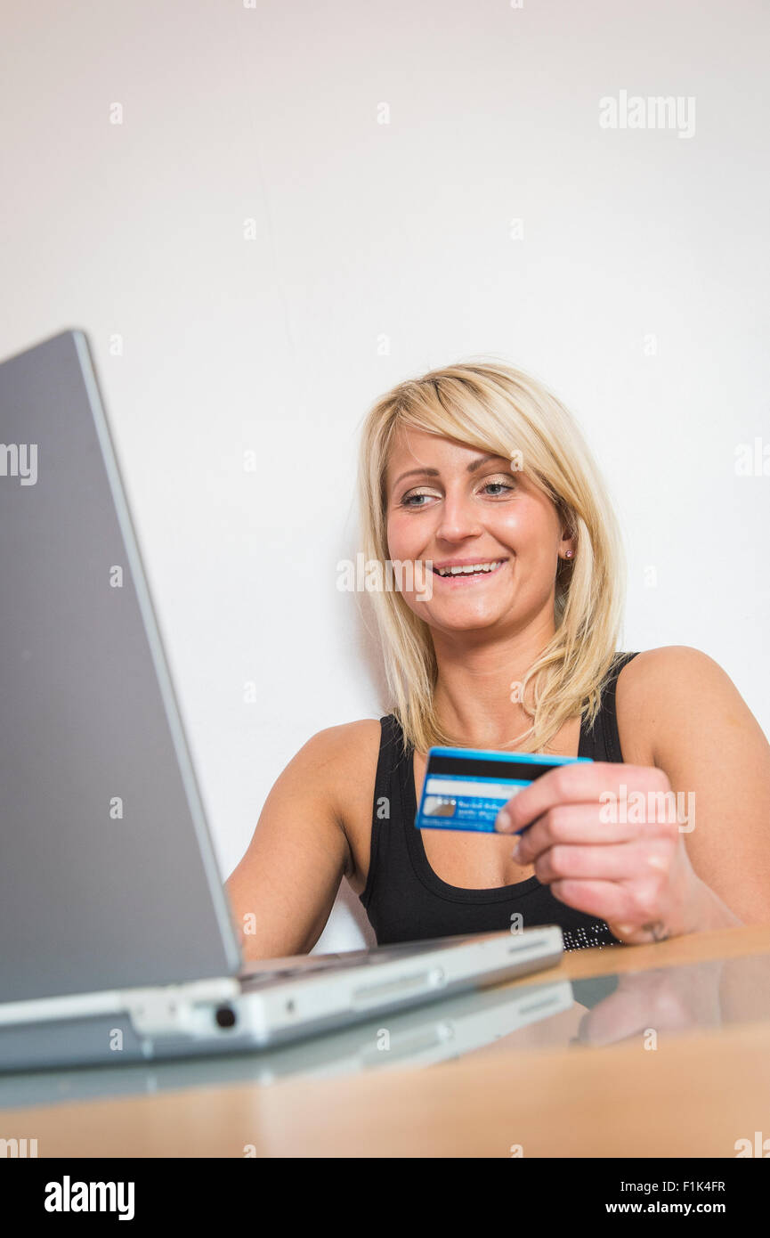 Lady using an apple laptop to shop online Stock Photo - Alamy