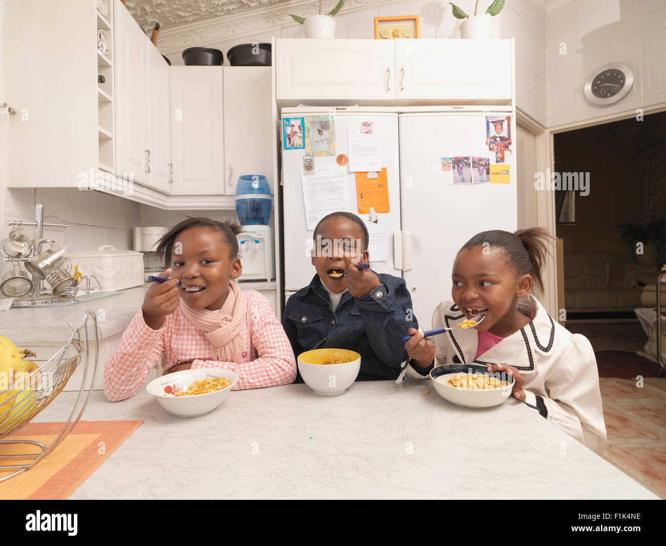 Girls eating breakfast cereal Stock Photo - Alamy