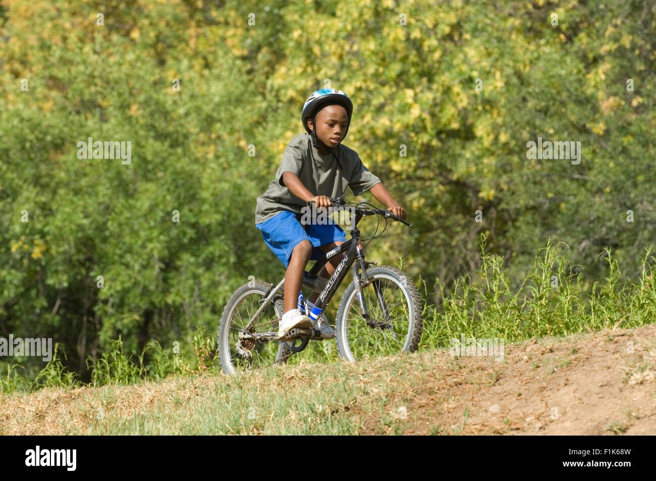 Boy riding bicycle Stock Photo - Alamy