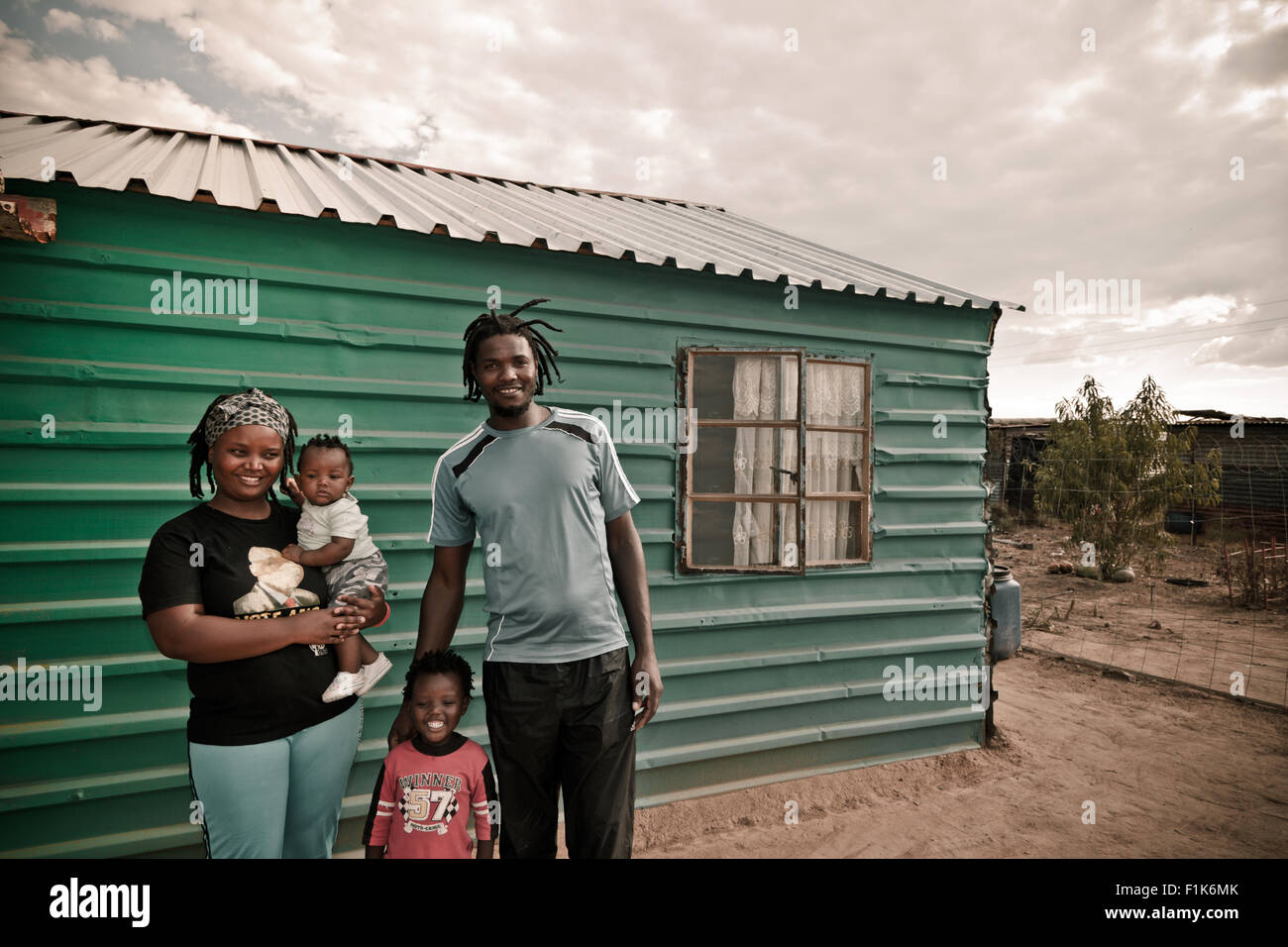 African family stand outside their rural home, smiling at camera Stock ...