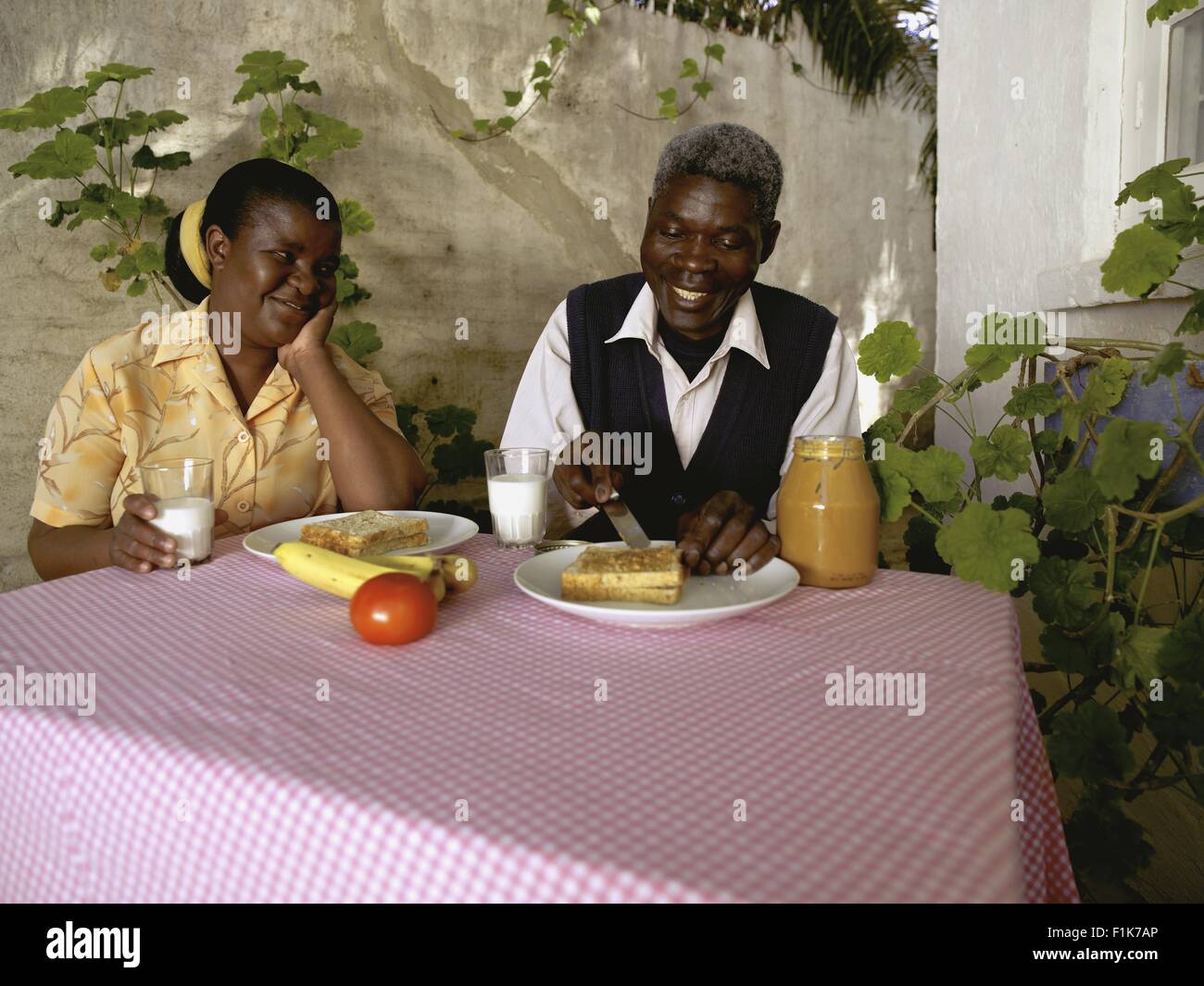 Senior Couple sitting on veranda having breakfast Stock Photo - Alamy