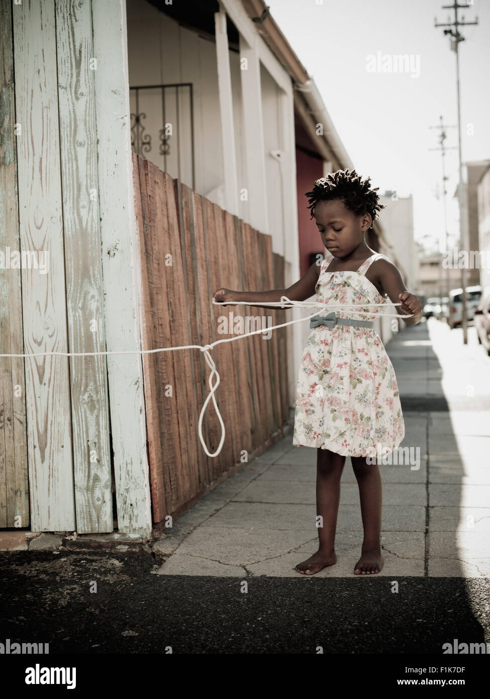 Girl untying knot in rope, Sophiatown, Cape Town, Western Cape Stock ...