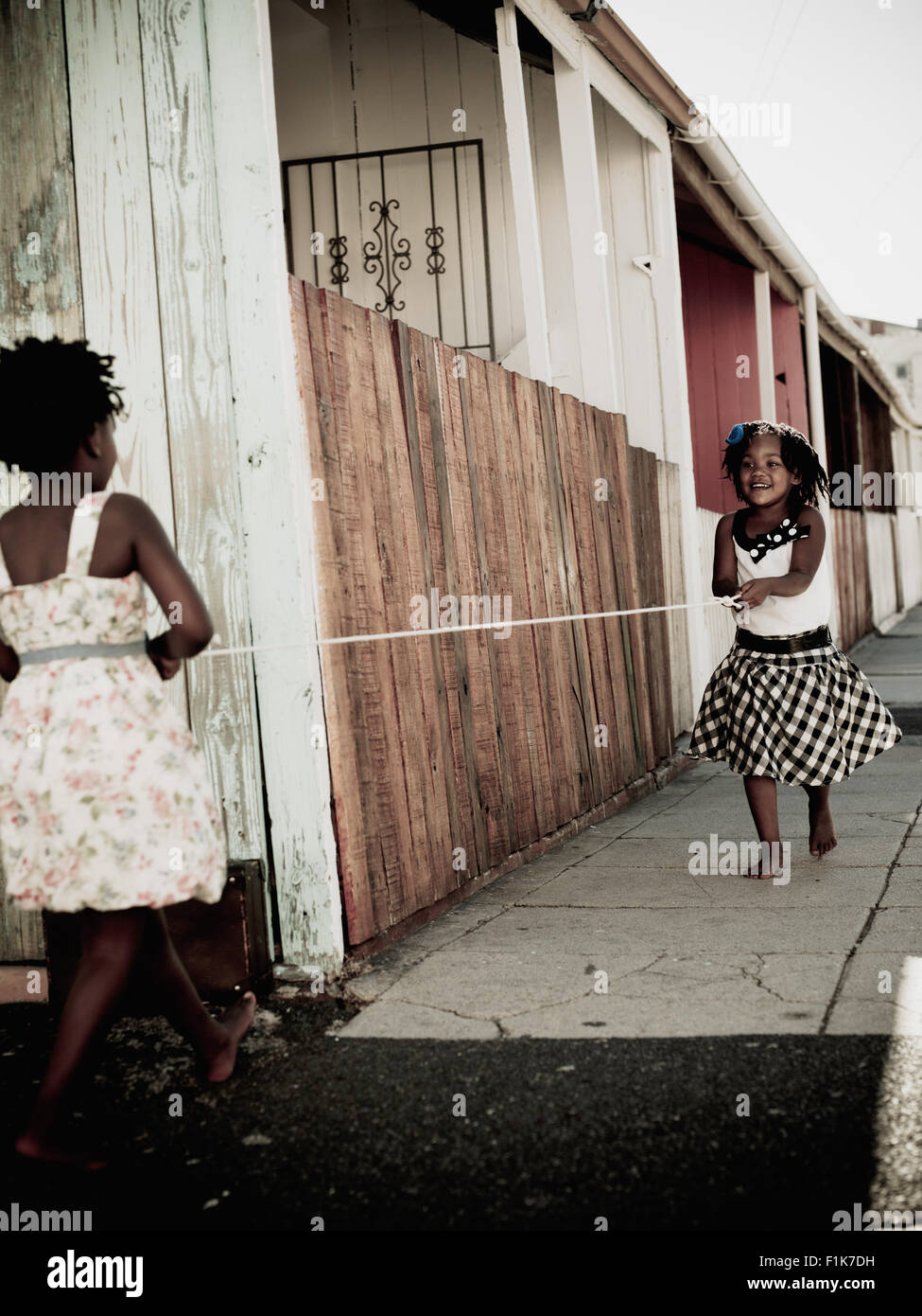 Two girls playing with a piece of rope, Sophiatown, Cape Town, Western ...