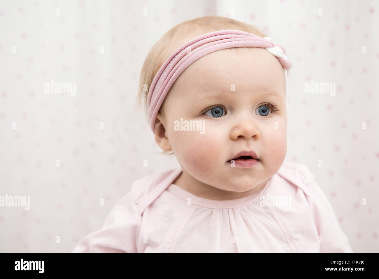 Close-up headshot of an infant girl with blue eyes Stock Photo - Alamy