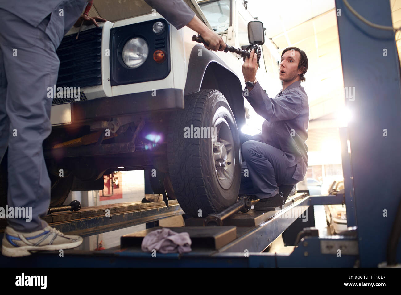 mechanics working in auto repair shop Stock Photo - Alamy