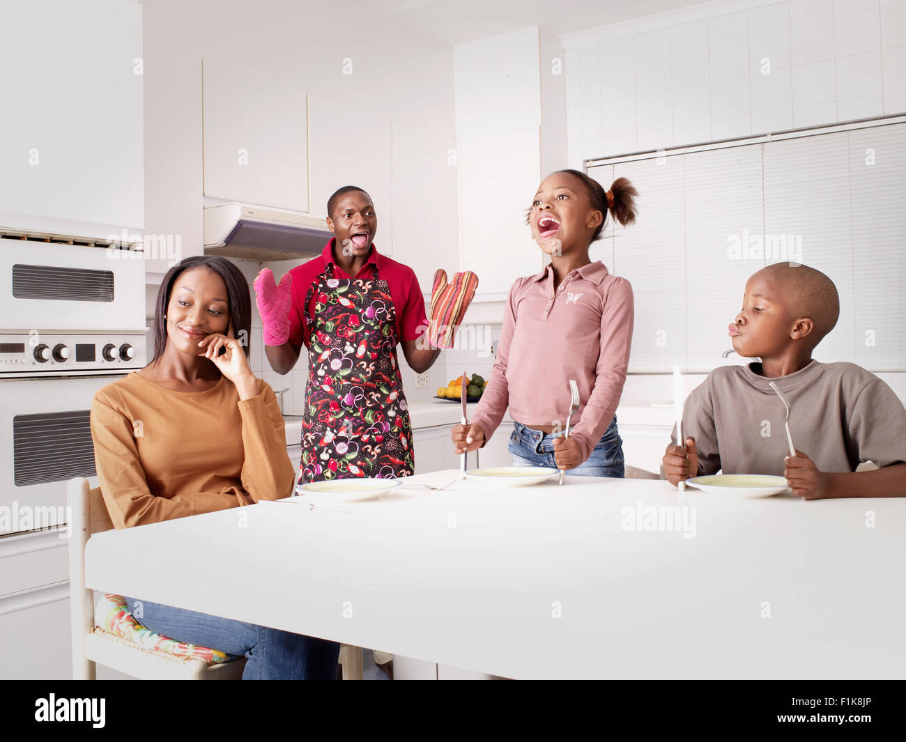 Parents with children (6-9) in kitchen, father and girl shouting Stock ...