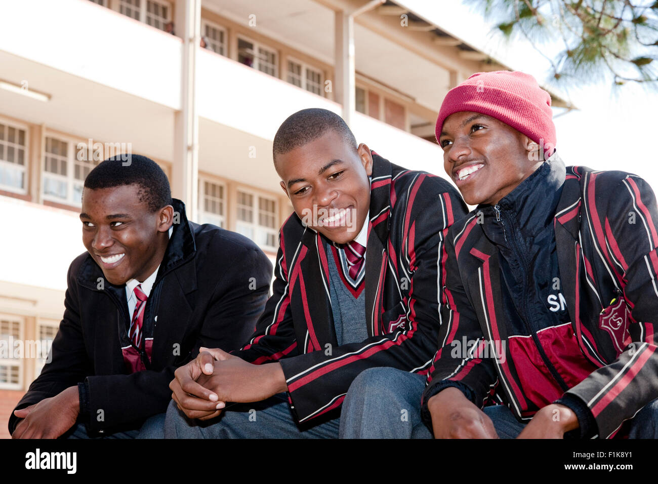 Three male high school friends sit together and smile Stock Photo - Alamy