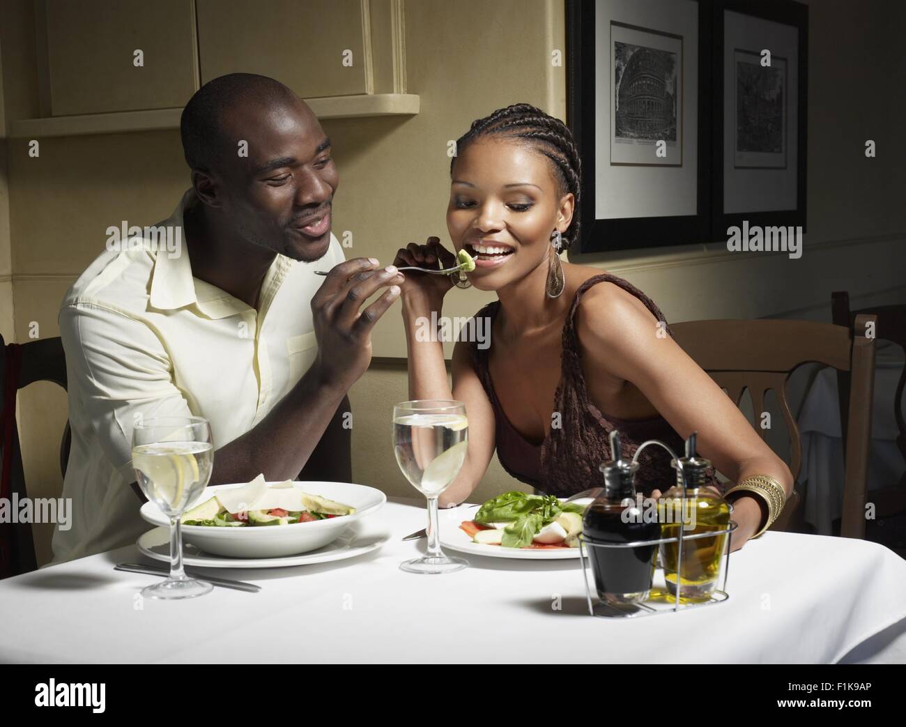 Couple eating at a table at a restaurant Stock Photo - Alamy
