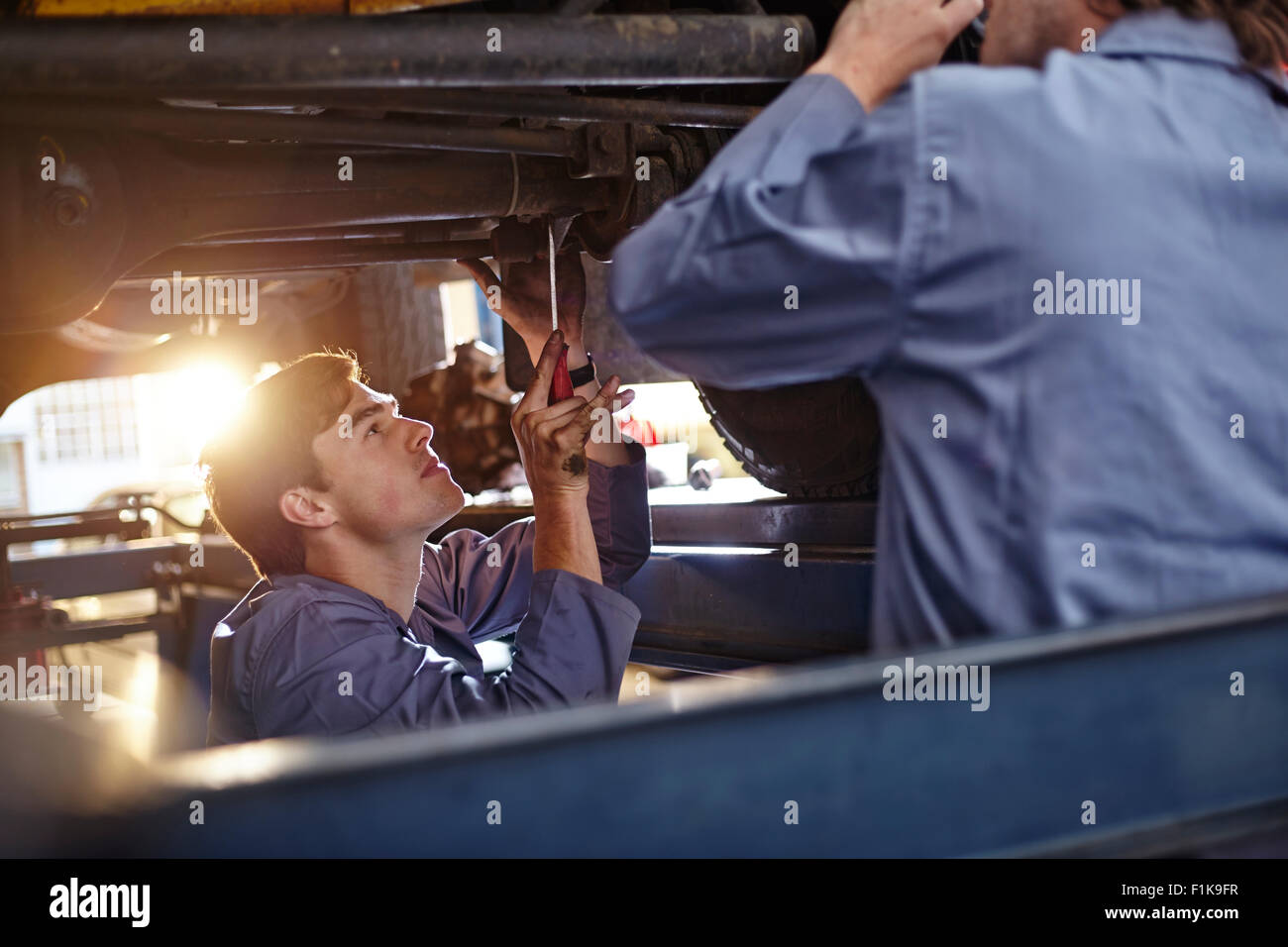 Mechanic working under car in hi-res stock photography and images - Alamy