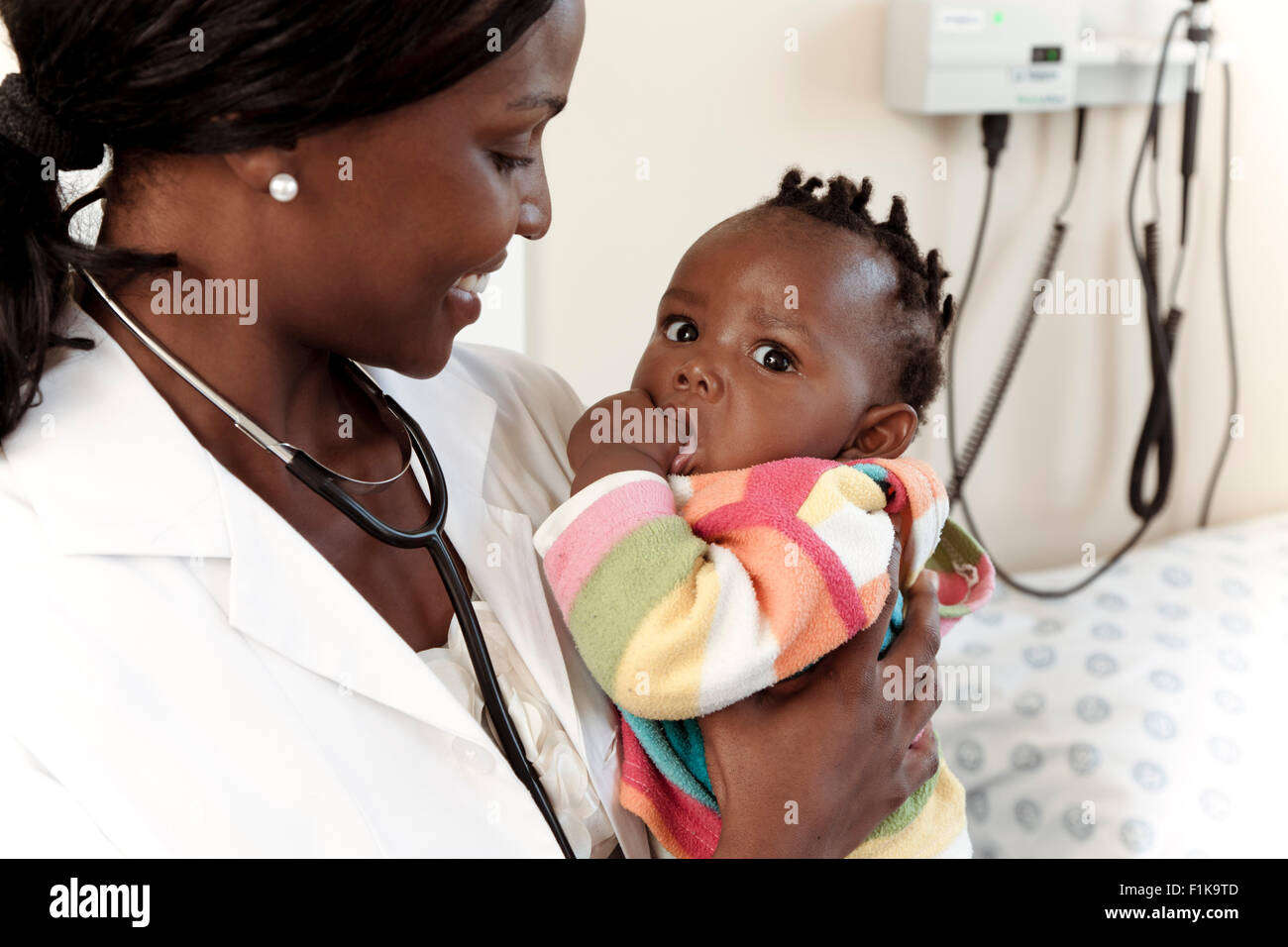 Closeup of an African female doctor holding an infant Stock Photo - Alamy