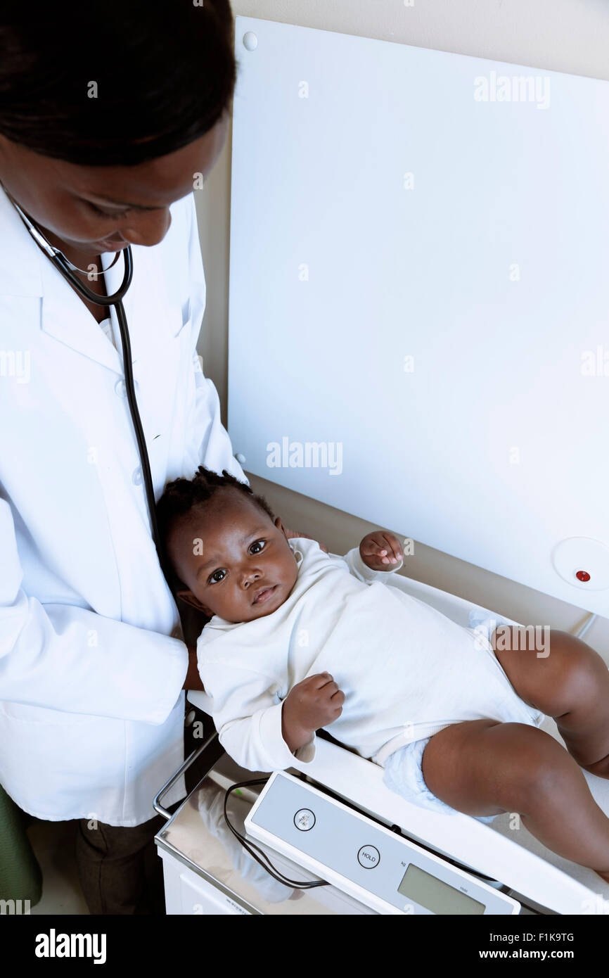 African female doctor examining an infant Stock Photo - Alamy