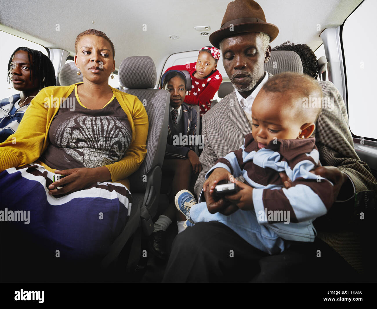 Elderly man holding baby in taxi Stock Photo - Alamy