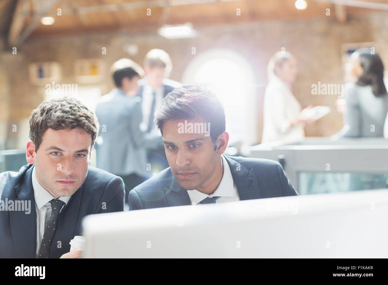 Serious businessmen using computer in office Stock Photo - Alamy