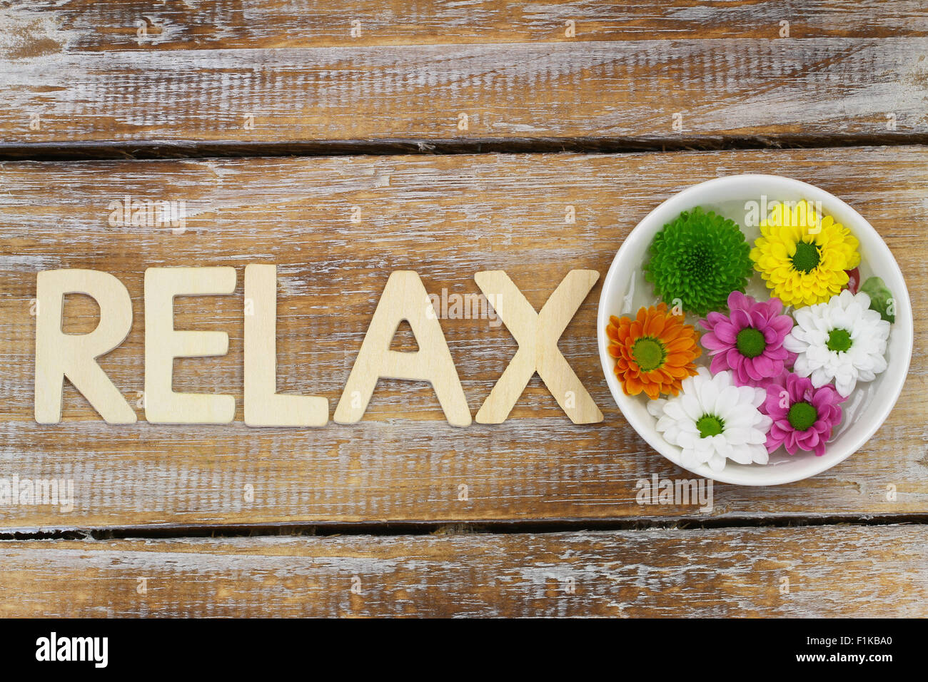 Relax written with wooden letters on rustic surface with Santini ...