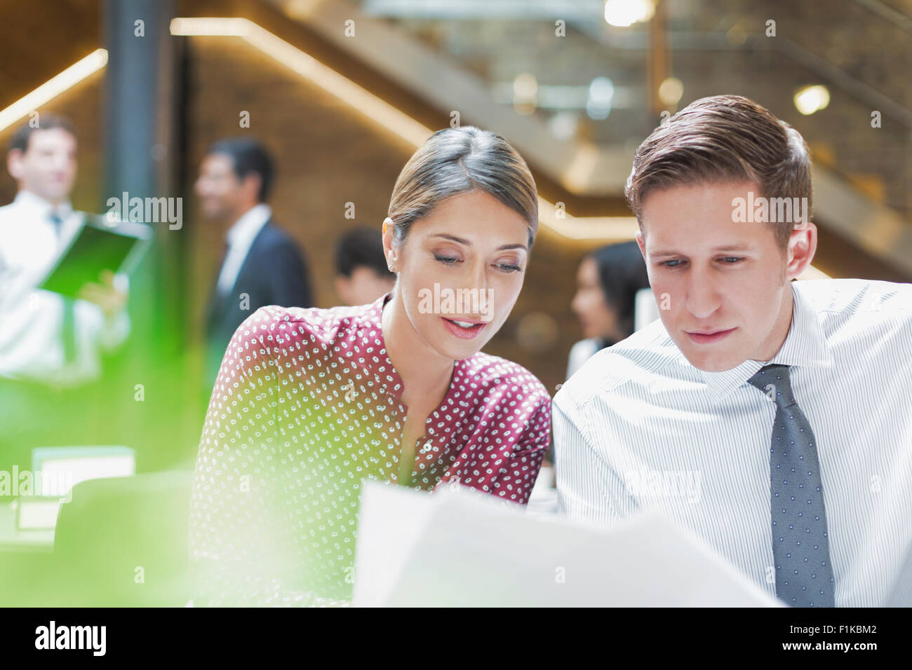 Business people reviewing paperwork in office Stock Photo - Alamy