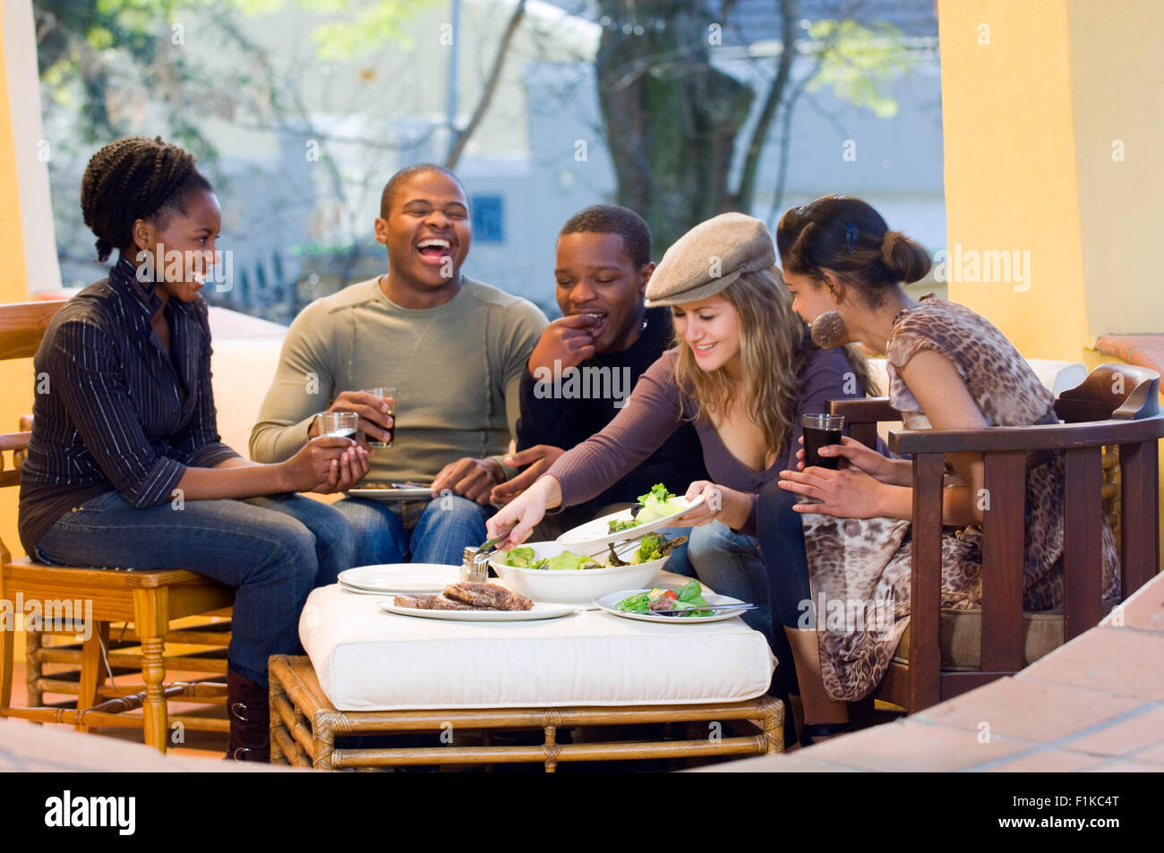Friends having lunch, laughing Stock Photo - Alamy