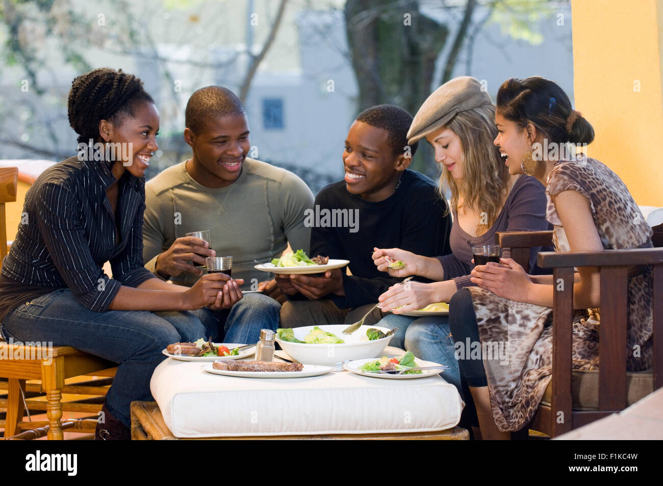 Friends having lunch, laughing Stock Photo - Alamy