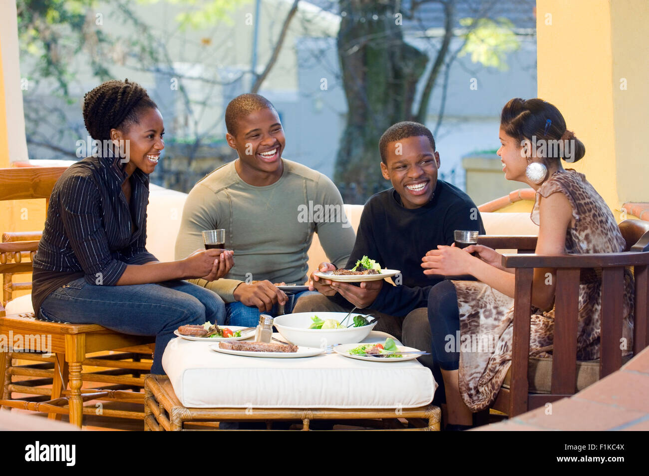 Friends having lunch, laughing Stock Photo - Alamy