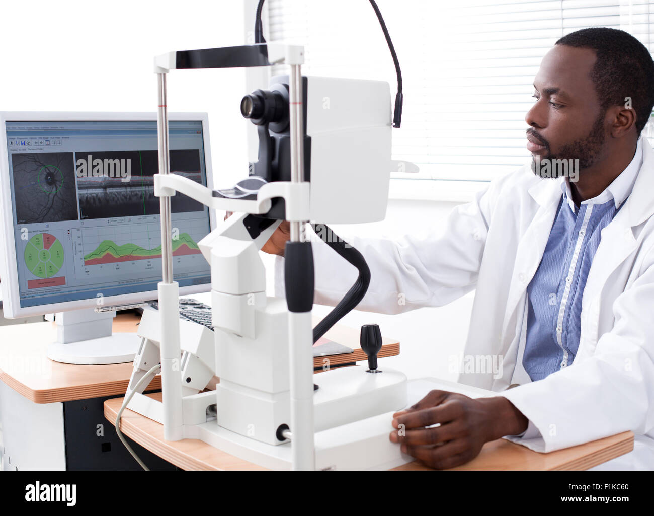 Optometrist looking at test results on his screen Stock Photo - Alamy