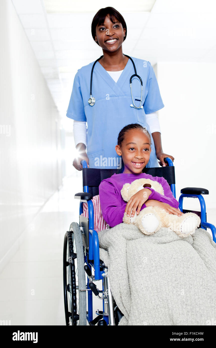 Doctor pushing wheelchair hi-res stock photography and images - Alamy