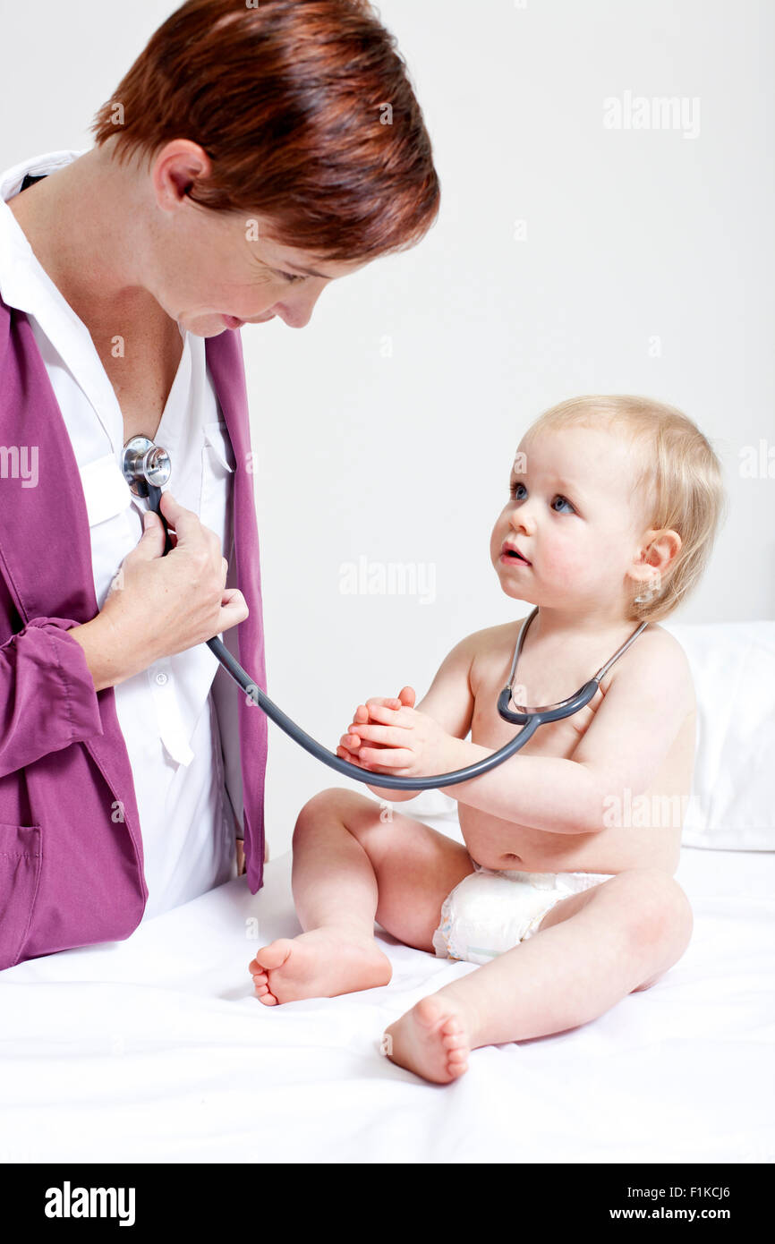 A baby playing paediatrician Stock Photo - Alamy
