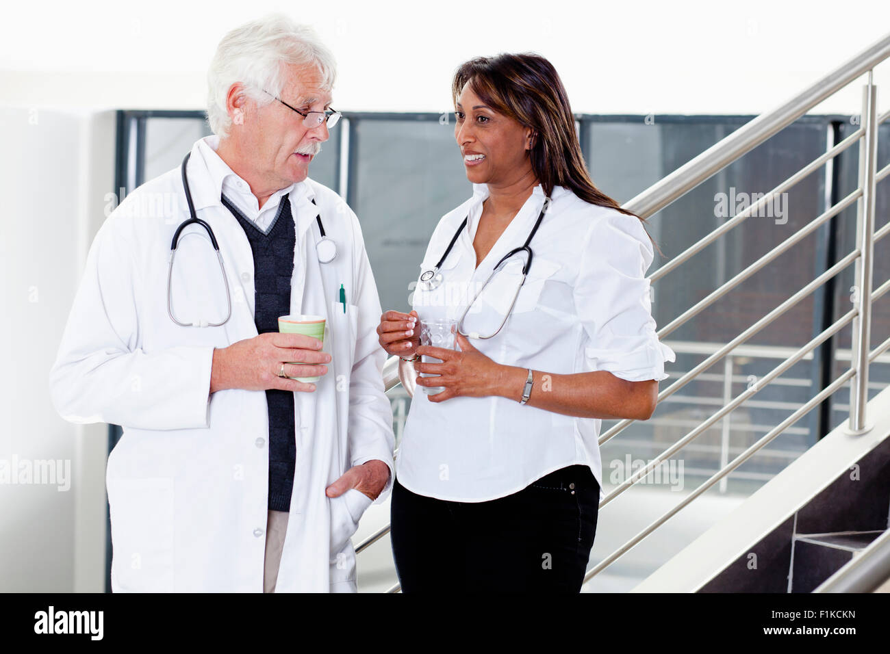 Two doctors smiling camera hi-res stock photography and images - Alamy