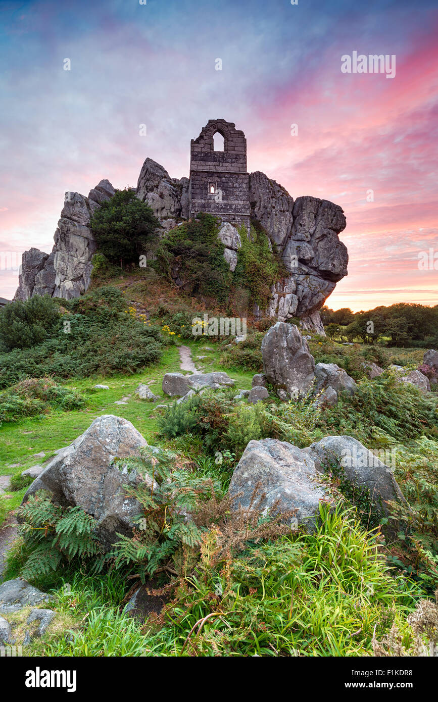 Dramatic fiery sunset over Roche Rock, a craggy outcrop of granite with ...