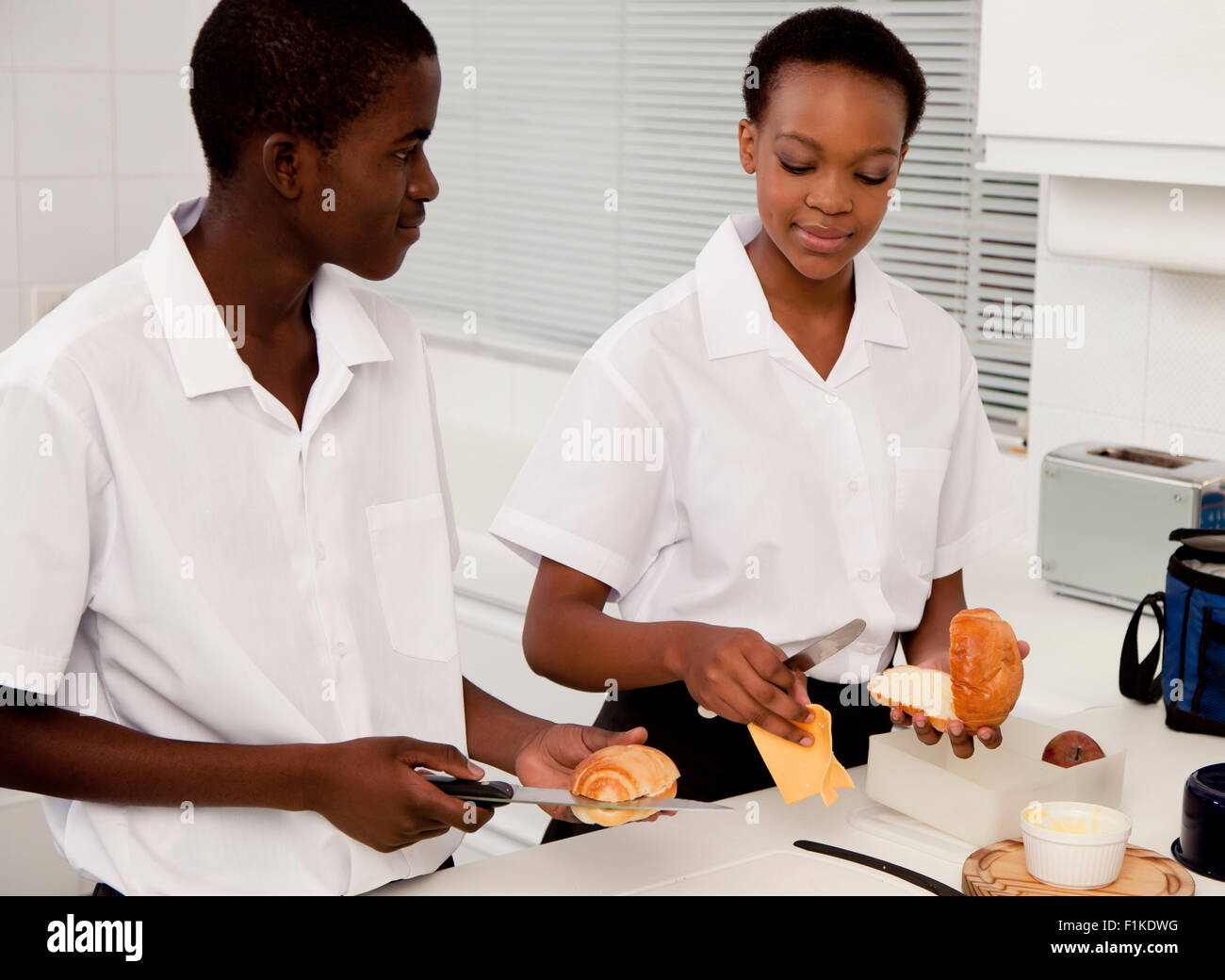 Two African teenagers making food together Stock Photo - Alamy