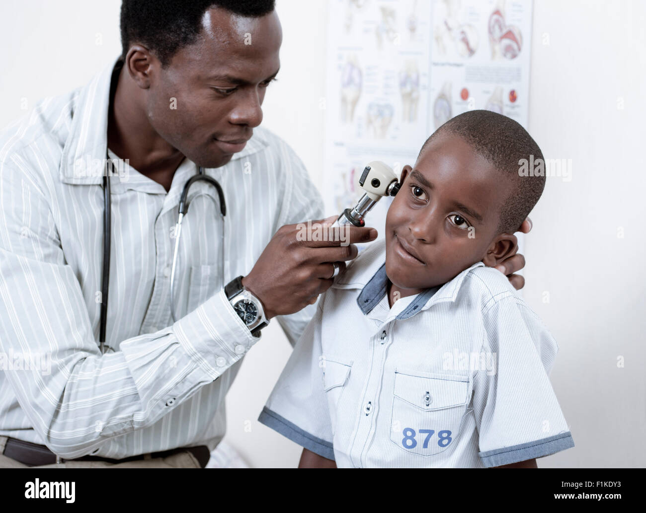 Doctor examining male African child in a doctor's room Stock Photo - Alamy