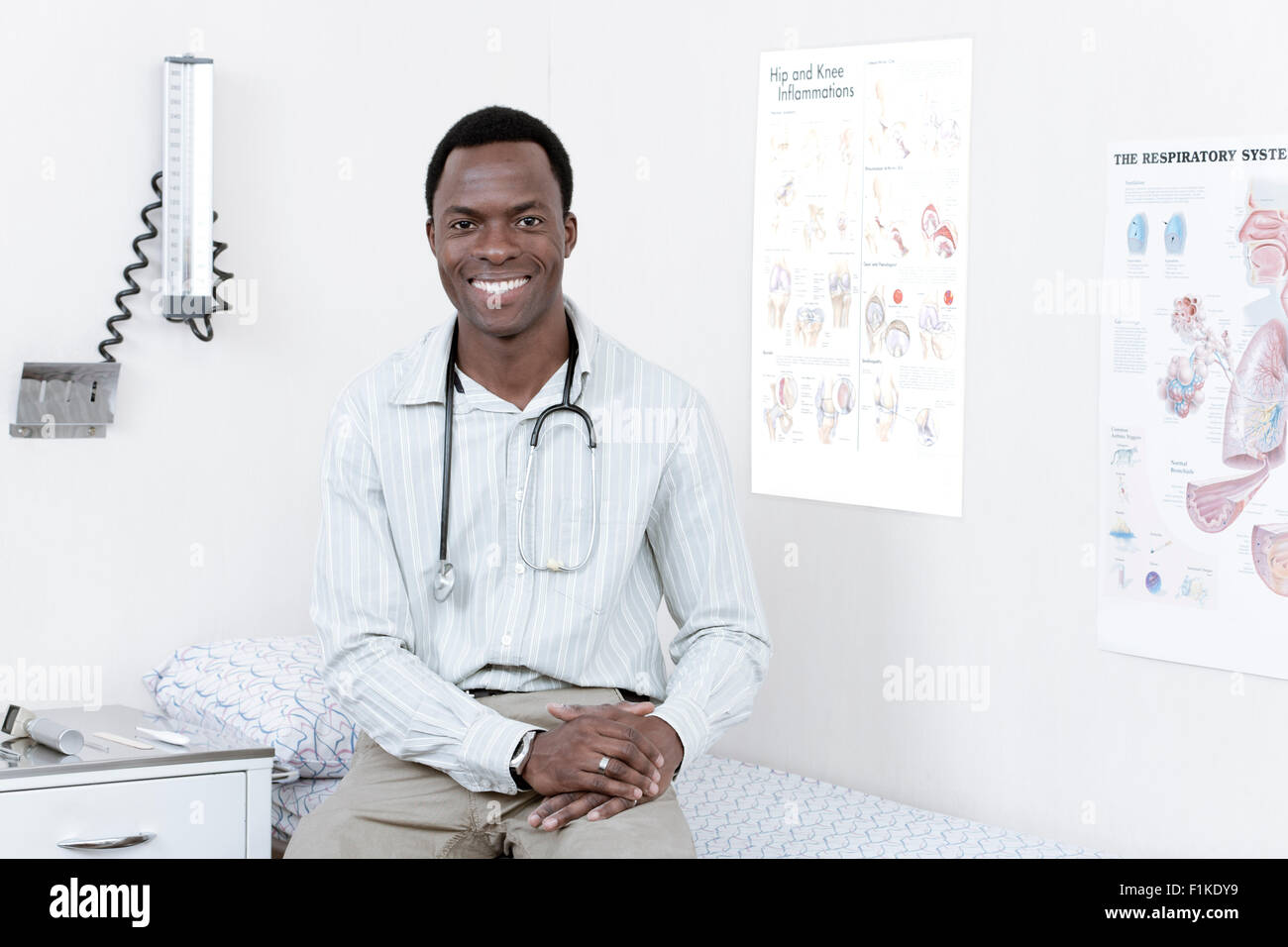 Male African doctor looking at camera, smiling Stock Photo - Alamy
