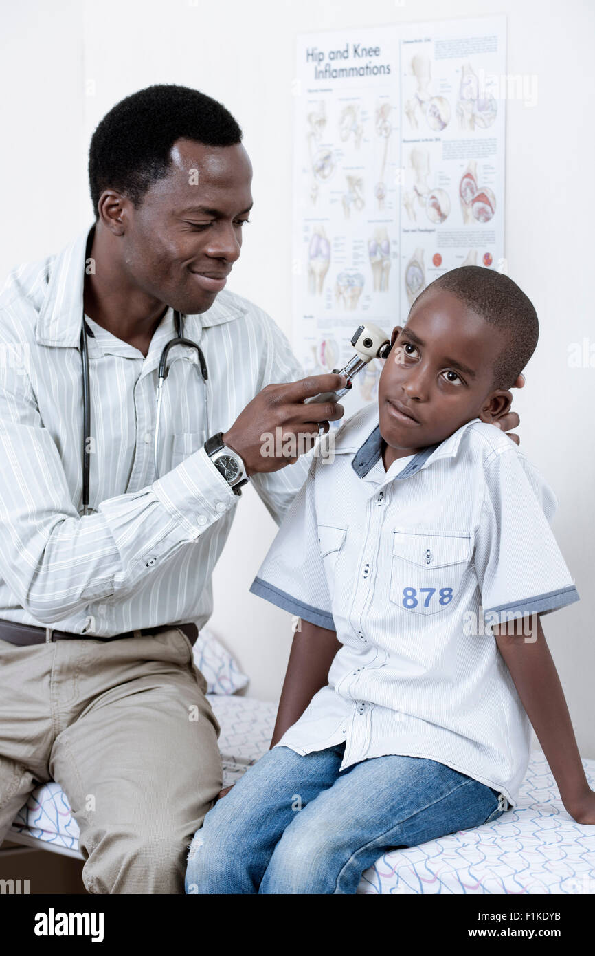 Doctor examining male African child in a doctor's room Stock Photo - Alamy
