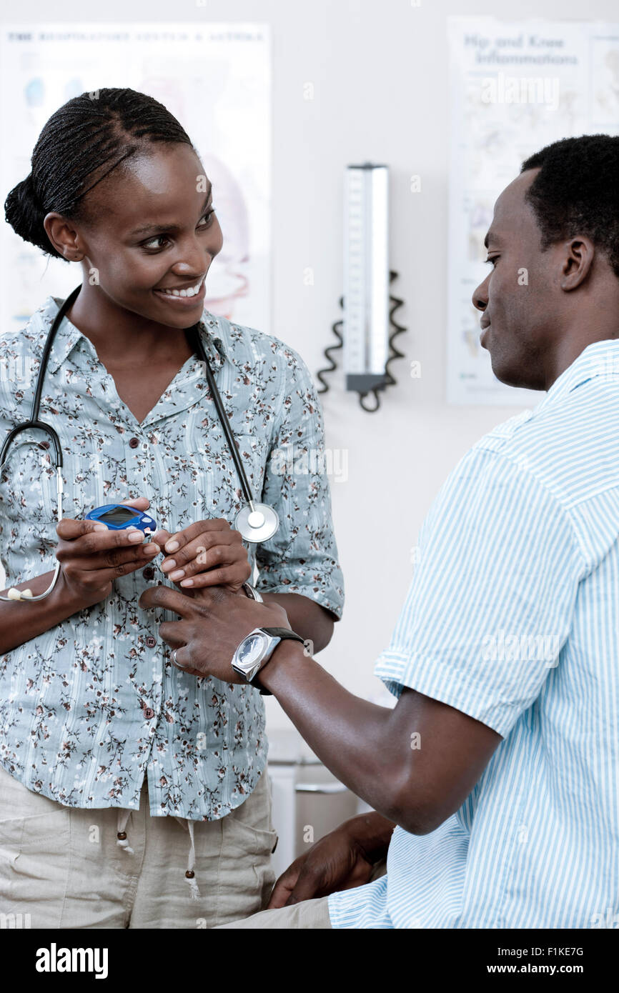 Female African doctor consults young African man Stock Photo - Alamy