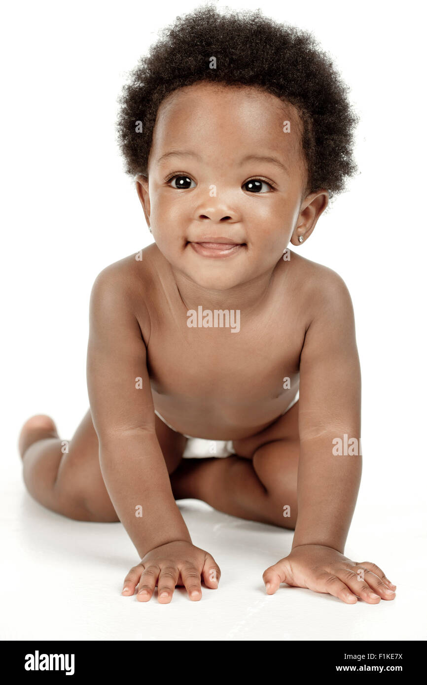 An infant sitting in front of a white background Stock Photo - Alamy