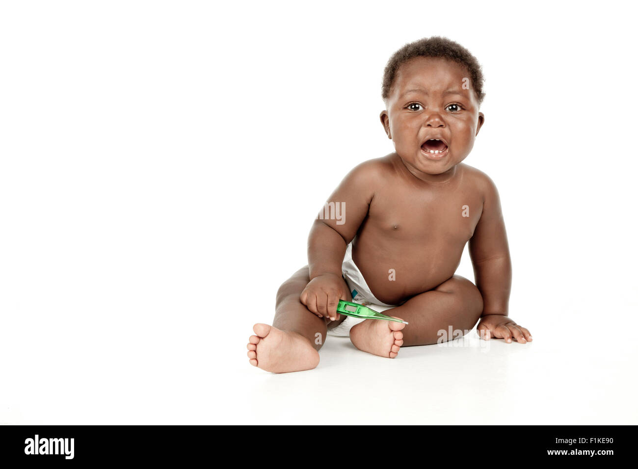 An infant sitting against a white background, crying Stock Photo - Alamy