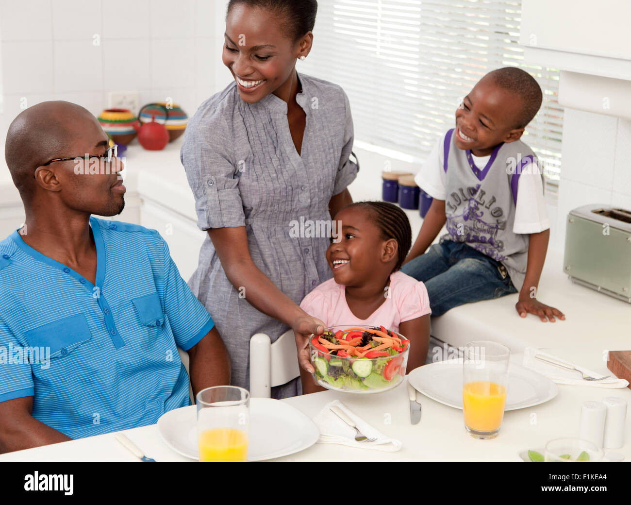 African family eat together in the kitchen Stock Photo - Alamy
