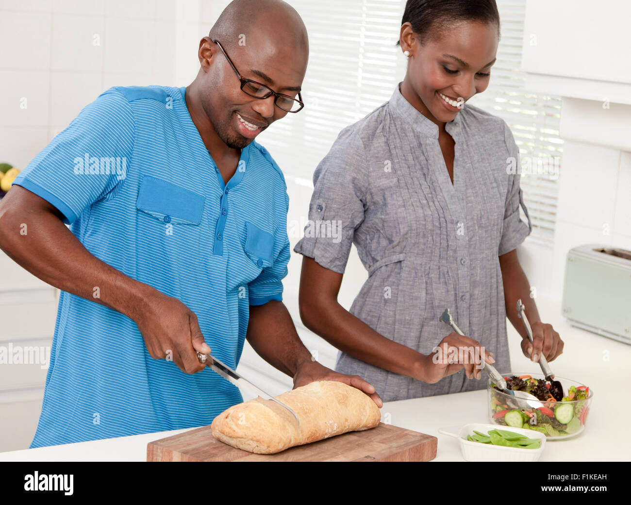Young African married couple making food together in the kitchen Stock ...