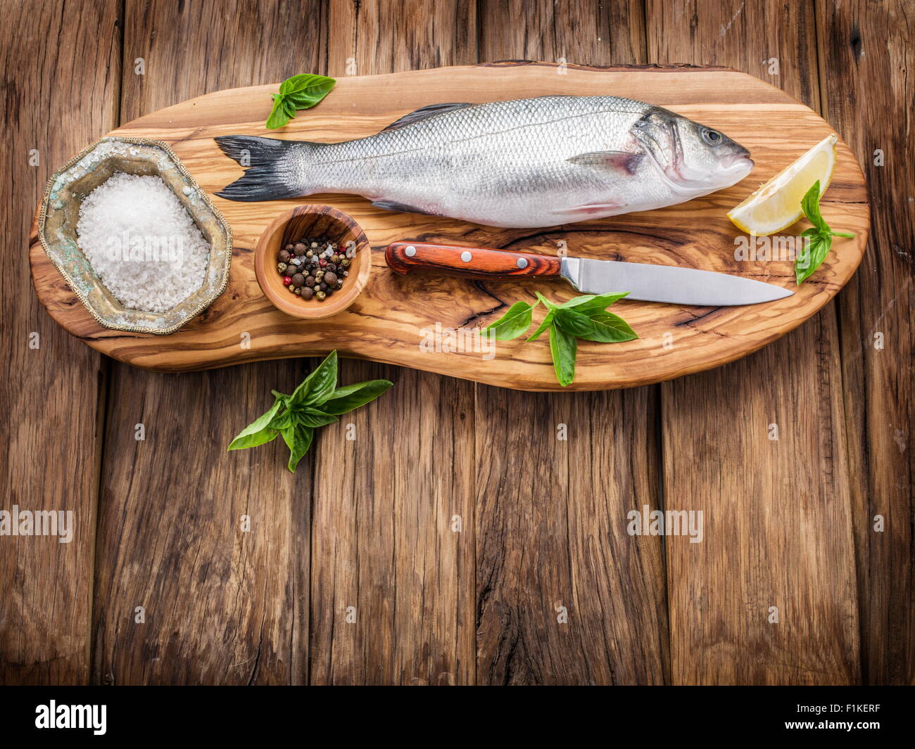 Sea bass fish on the graphite board Stock Photo - Alamy