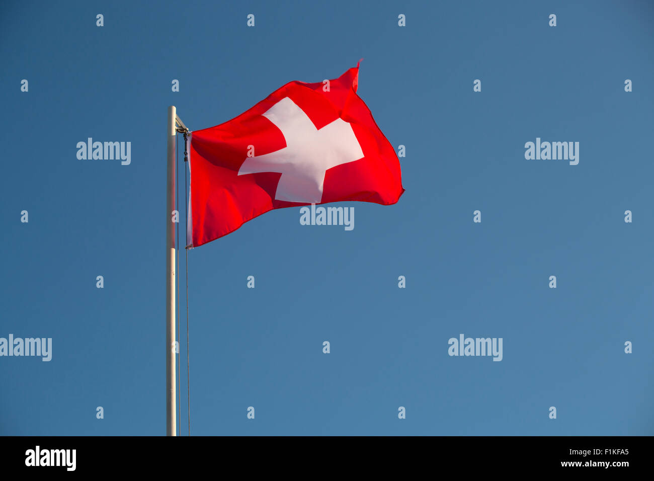 Switzerland flag in front of a blue sky Stock Photo - Alamy