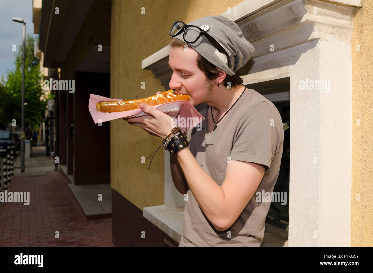 Student eating fast food in the break in front of school Stock Photo ...