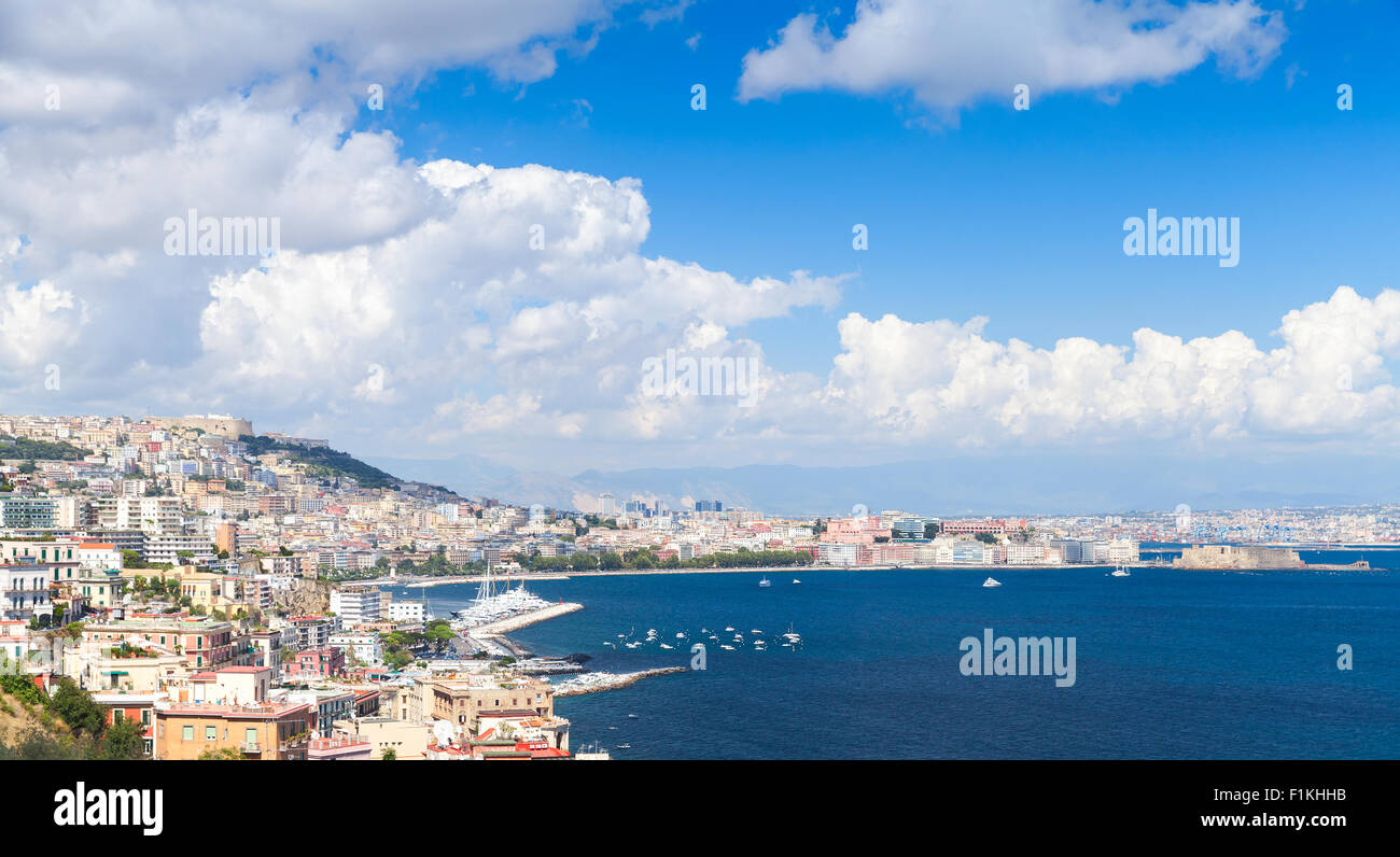 Gulf of Naples panoramic landscape with cityscape under blue cloudy sky ...