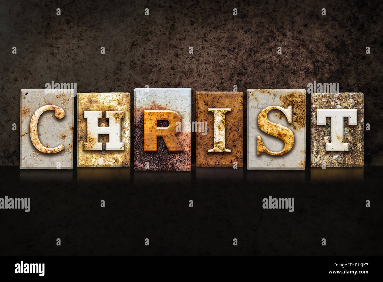 The name "CHRIST" written in rusty metal letterpress type on a dark ...