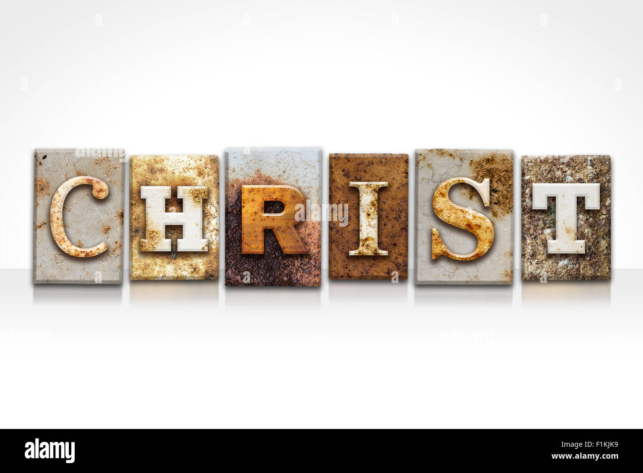 The name "CHRIST" written in rusty metal letterpress type isolated on a ...