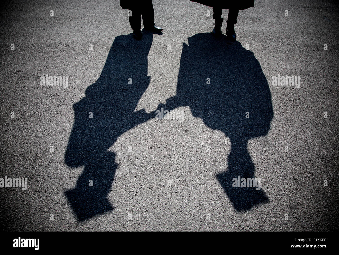 The shadows of two young students on graduation day at University of ...