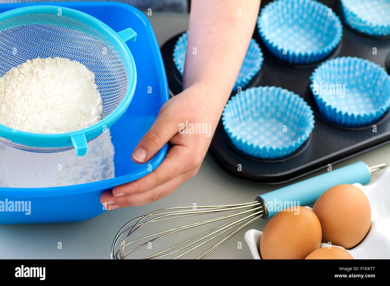 Boy or Girl Baking, sieving flour with clean hands and fingernails ...